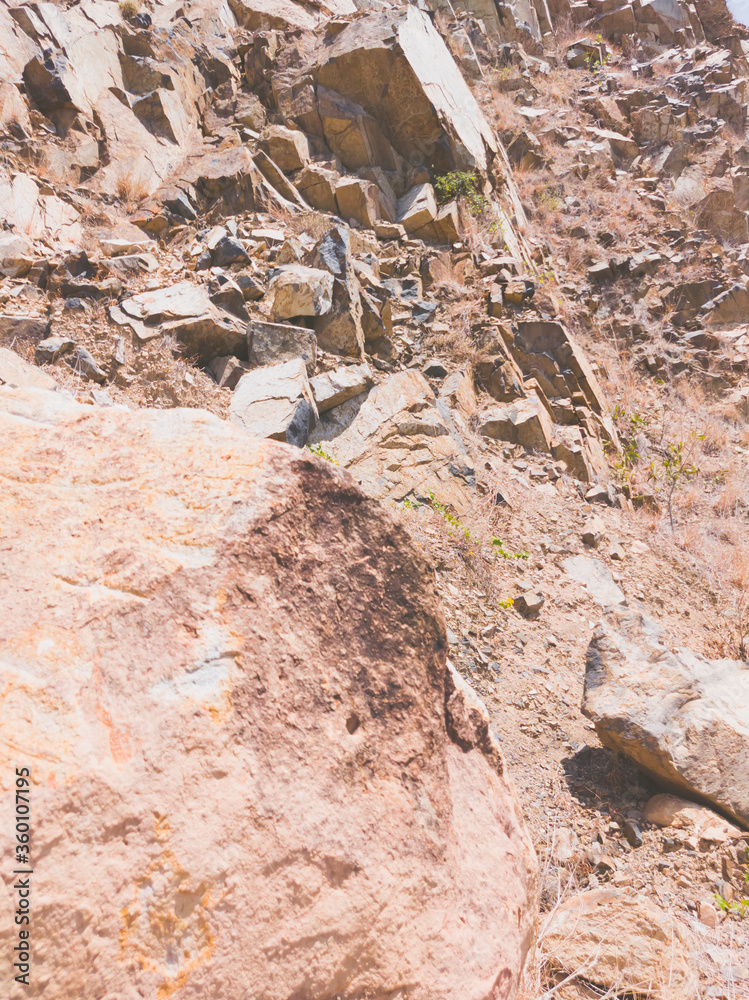 Natural background. Closeup edged shabby cliff cracks. Gray-brown stone ...