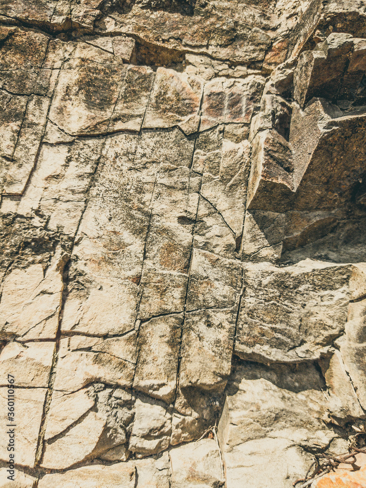 Natural background. Closeup edged shabby cliff cracks. Gray-brown stone ...