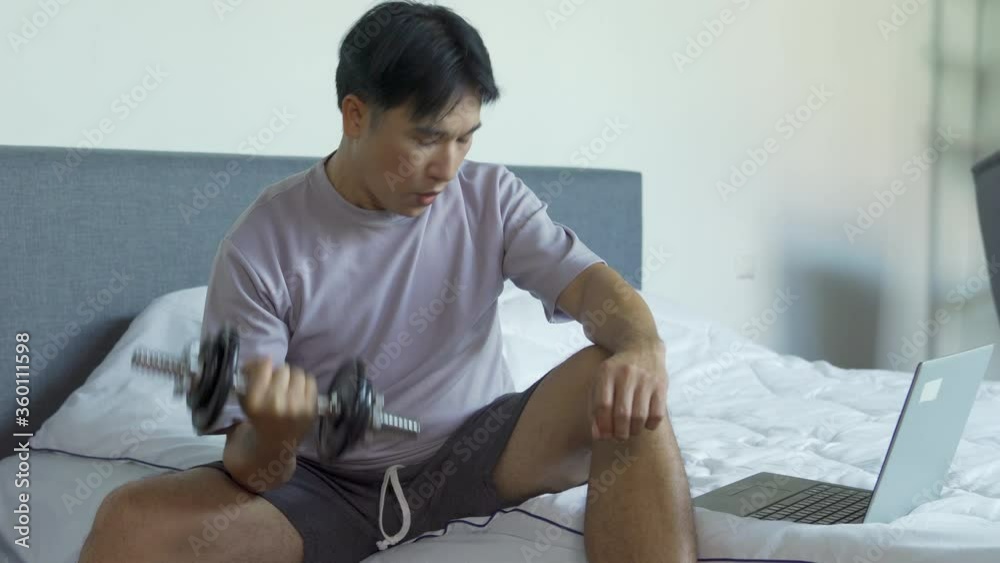 4K Middle aged Asian man do workout exercise with weight dumbbell on ...