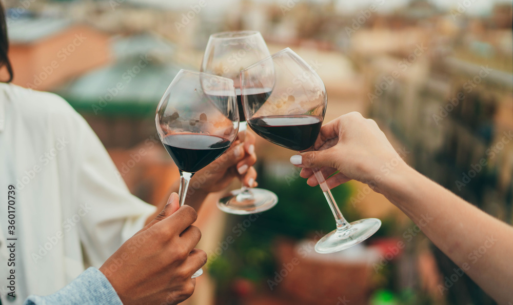 Outdoor summer party on rooftop, Group of young people toasting outside ...