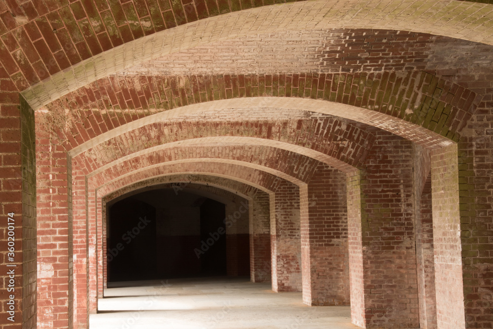 Infinity view of curved, blonde and red brick tunnel with rectangular ...