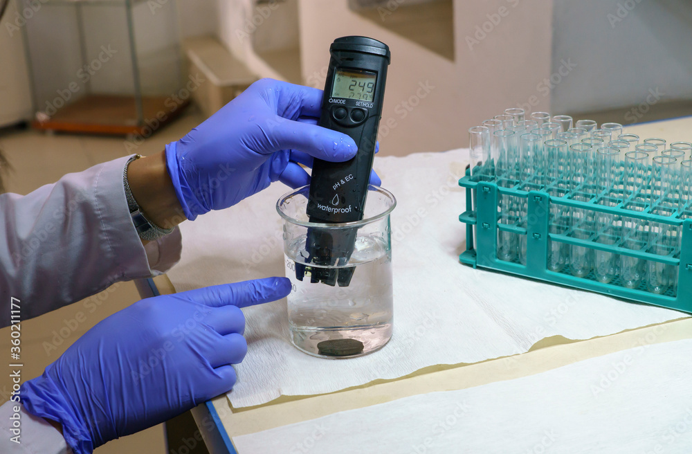 Digital water test in girl hand, water analysis technology. Digital pH ...