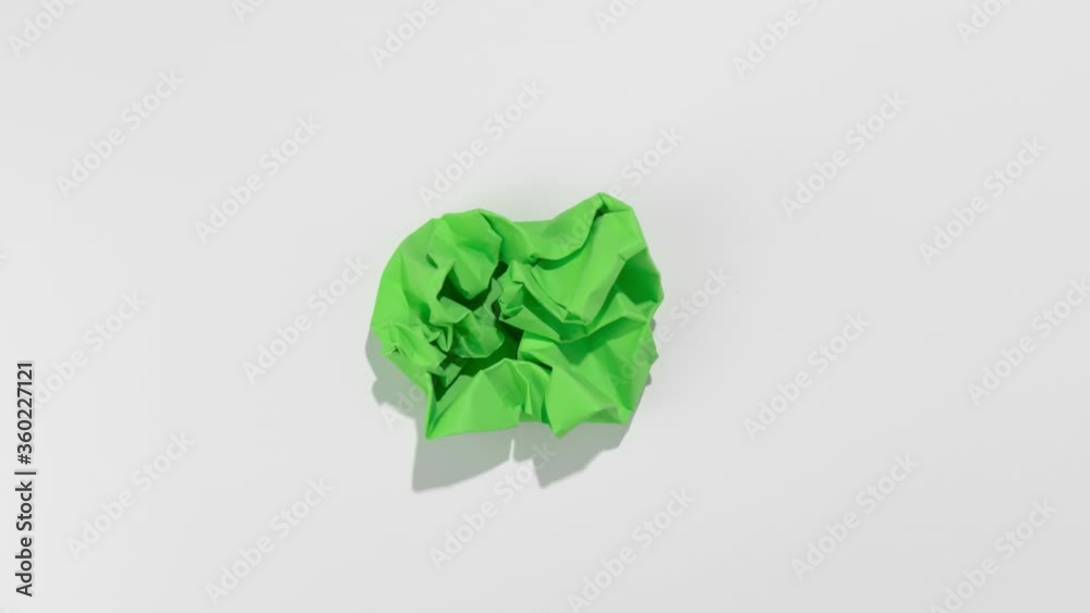 Stop Motion Animation_Green paper ball unwrapping on white background ...