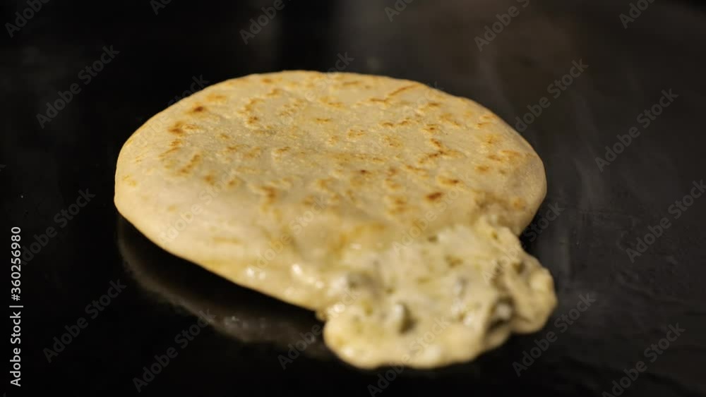 Camera pans back in slow motion to reveal a hot Salvadoran pupusa ...