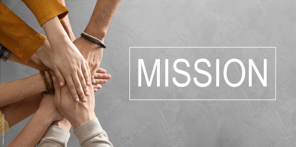 People holding hands together over grey background and text MISSION ...