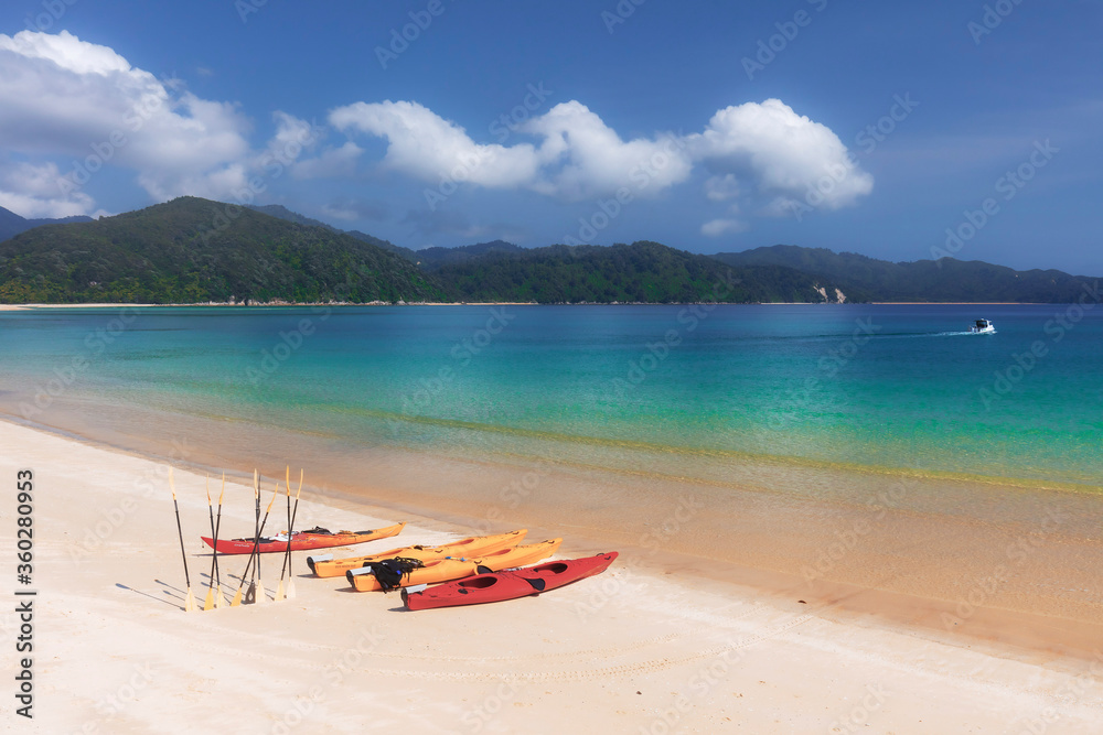Three kayaks on the beach at Awaroa Inlet along the Abel Tasman ...