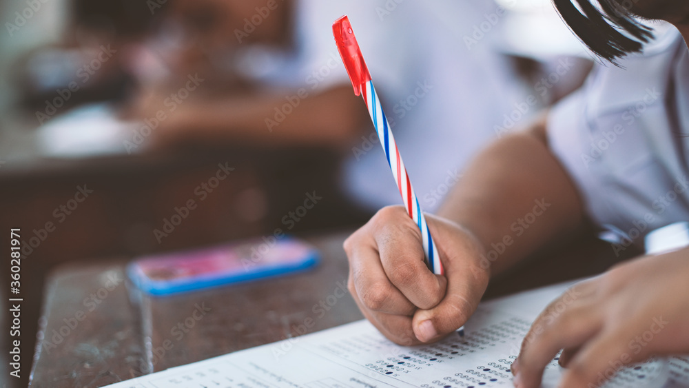 Students doing exam answer sheets exercises in classroom of school.16:9 ...
