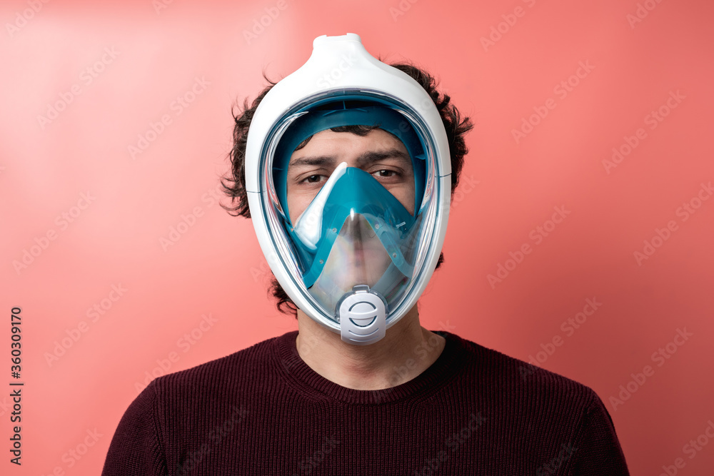 Man with underwater mask, Covid-19 protection, coloured background ...