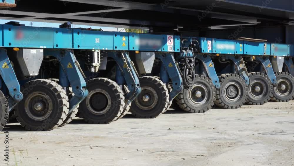 Heavy industrial self propelled modular trailer moving a train railway ...