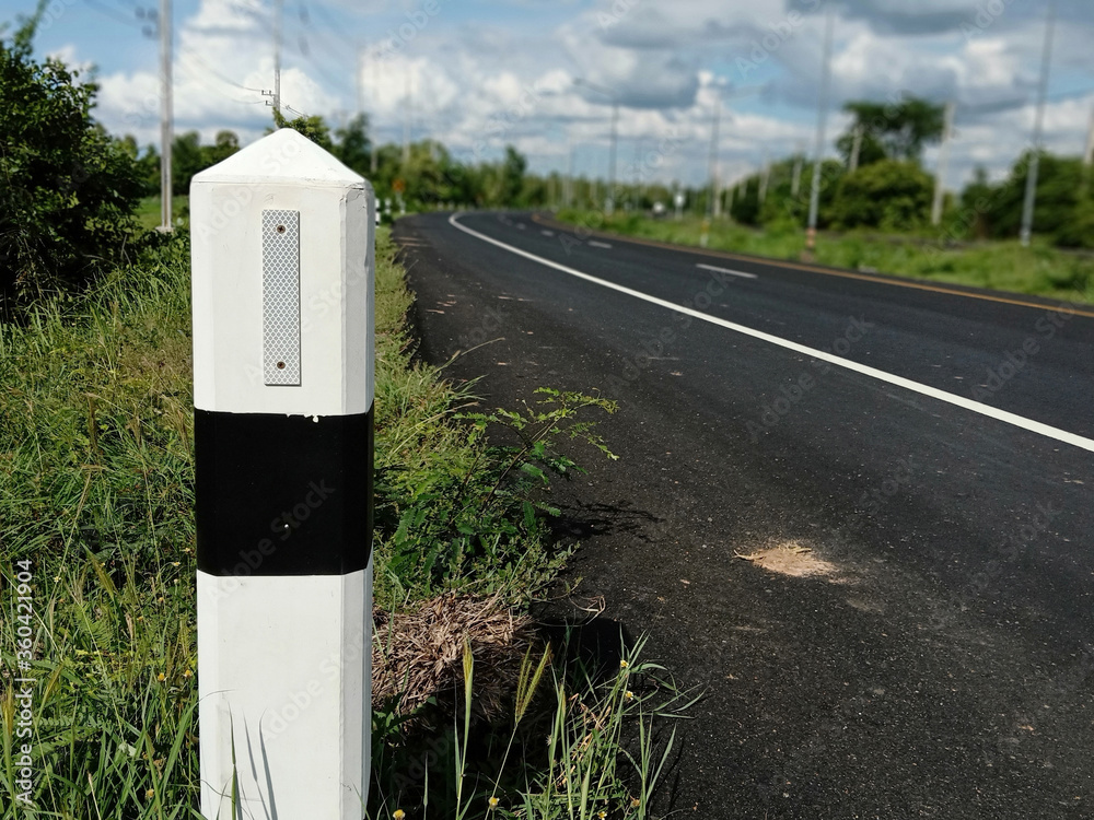 Pillars to guide the curved path of the road. Stock Photo | Adobe Stock