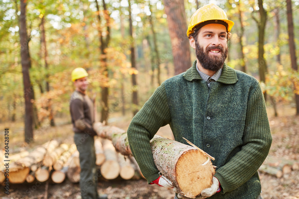 Forest worker or lumberjack at the wood harvest Stock Photo | Adobe Stock