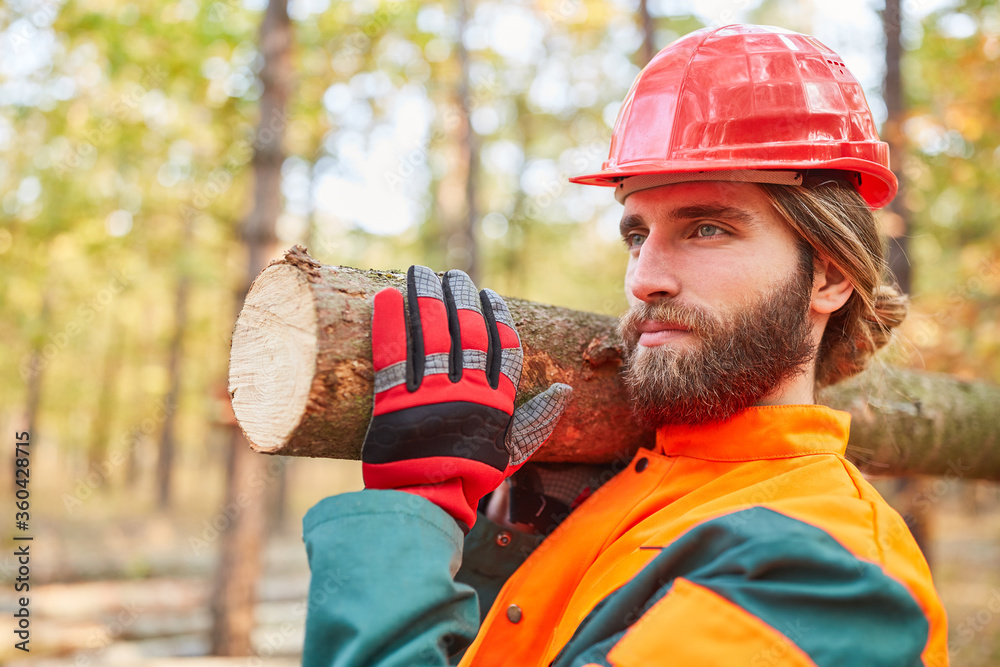 Forest worker while carrying tree trunk Stock Photo | Adobe Stock