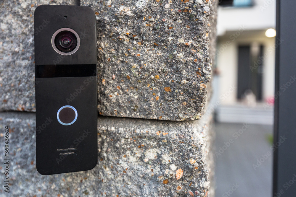 Outdoor video intercom system with speaker mounted on the stone wall ...