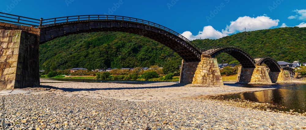 Famous historical wooden arch Kintai Bridge spanning the Nishiki River ...