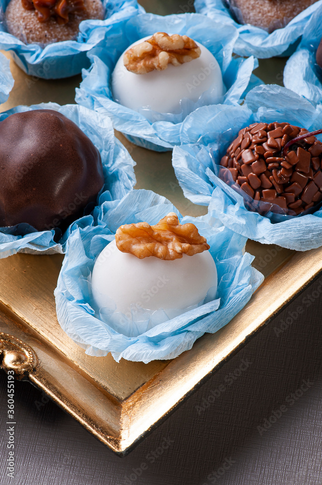 .Various types of gourmet brigadeiro on a golden tray. Cameo ...