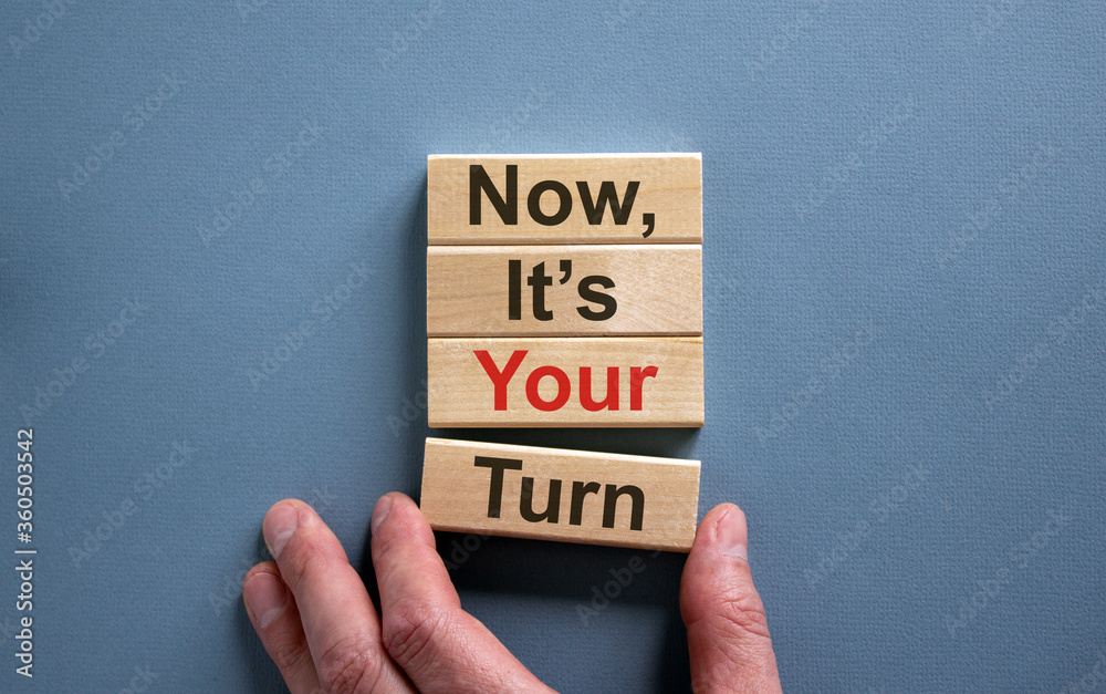 Wooden blocks form the words 'now, it's your turn' on beautiful blue ...