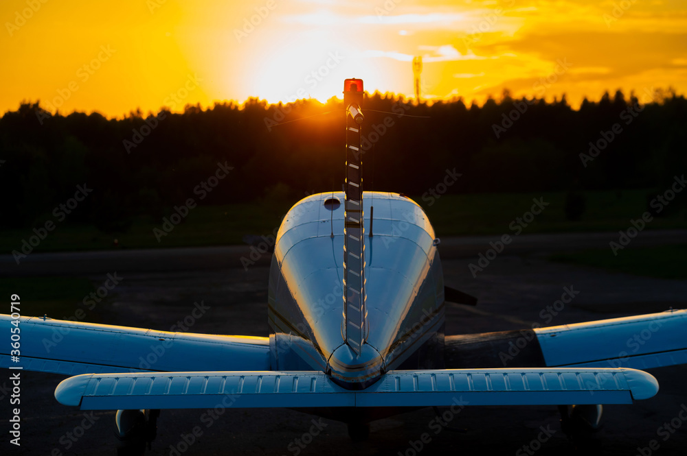 Quadruple aircraft parked at a private airfield. Rear view of a plane ...