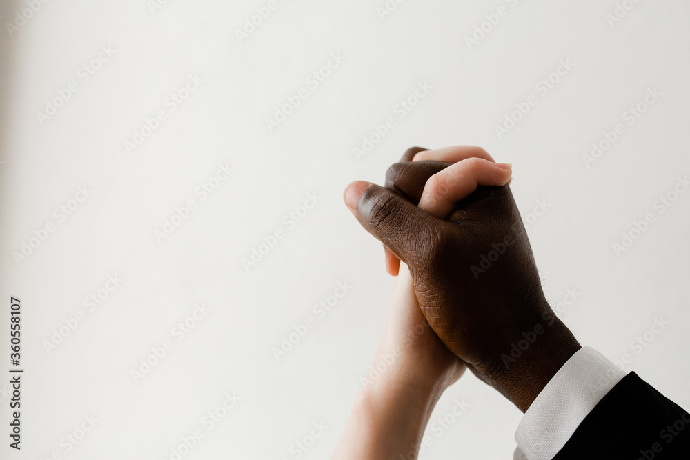 Profile of arm black man was gripping the arm of a white woman as a ...
