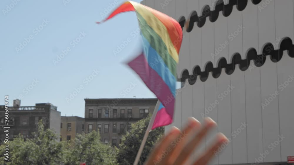 LGBTQ rainbow flag close up, hands waving, New York City Pride Month ...