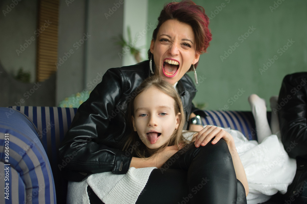 Crazy mother in black leather jaket and pants hugging her little ...