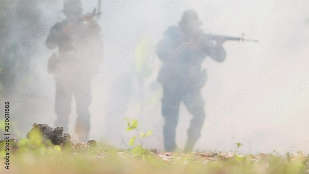 Group of soldier walk through fog from war fighting and they point gun ...