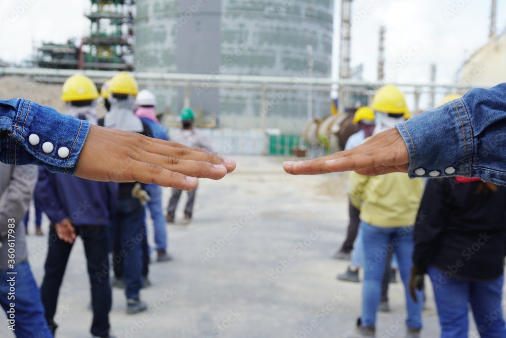 Hands of the workers unfolded to measure the distance during line up to ...