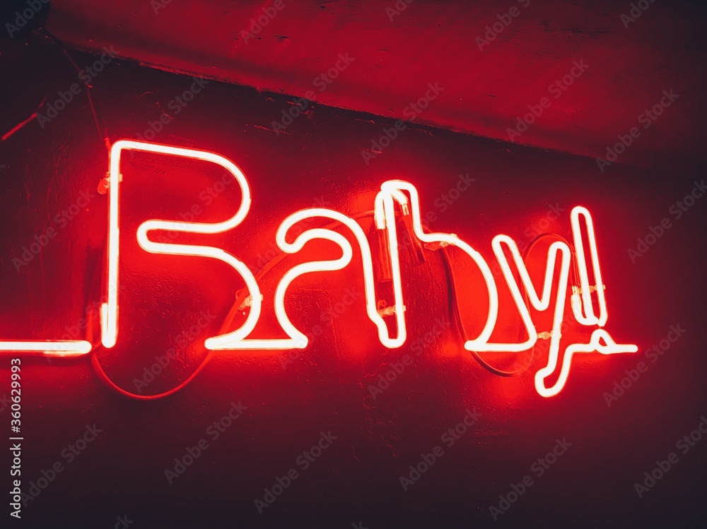Bright red neon sign, outlined baby word in bar. Night club and bar ...