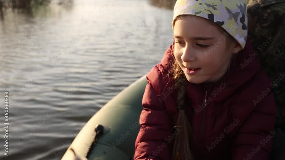 girl with help of her father rowing in boat. dad and daughter float ...