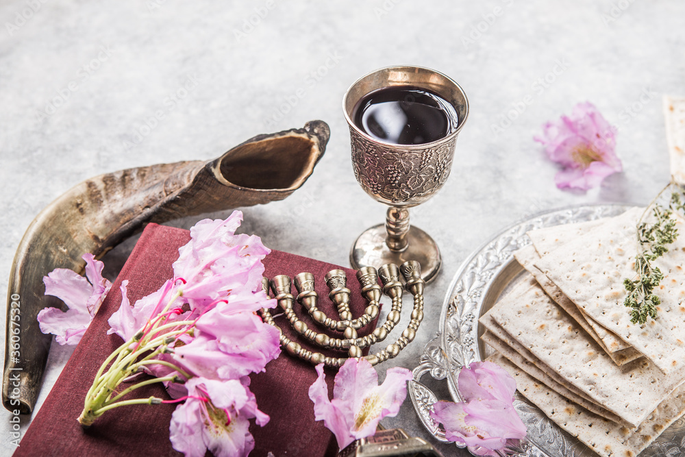 Metal plate with matzah or matza, Kiddush Cup, Shofar horn on a light ...