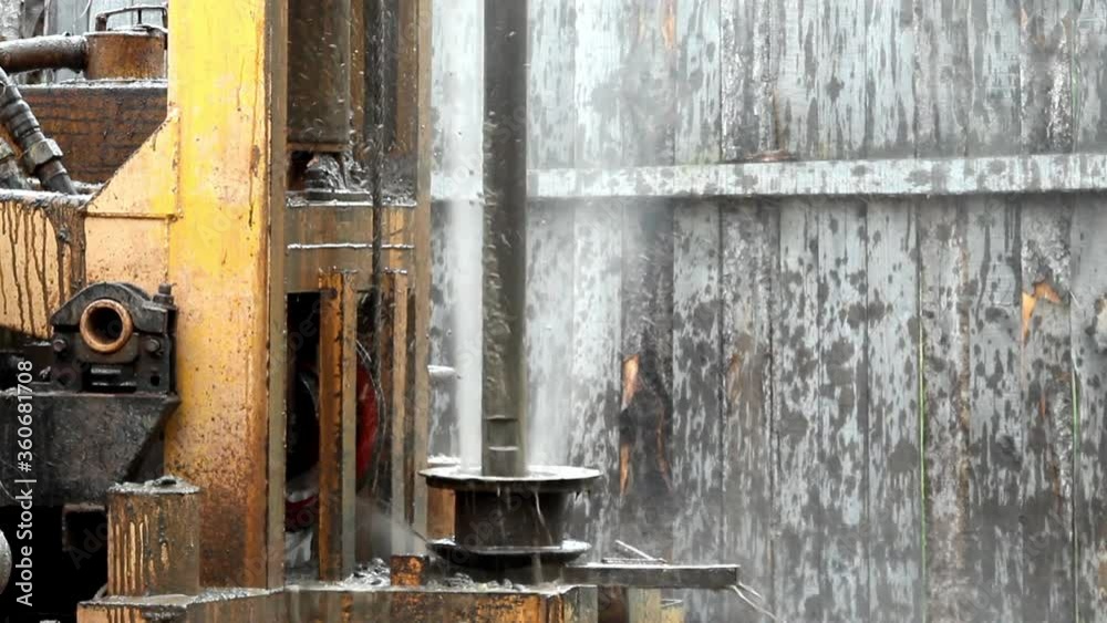 Powerful jet of water and mud comes from the well.Water well drilling ...