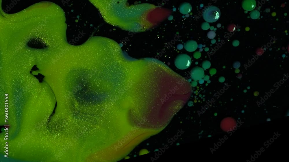 Abstract multi colored paint droplets moving and changing form on ...