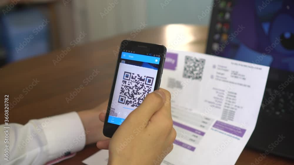 Video Stock QR Utility Bill. Mobile Bill Payment with QR Codes. A woman ...