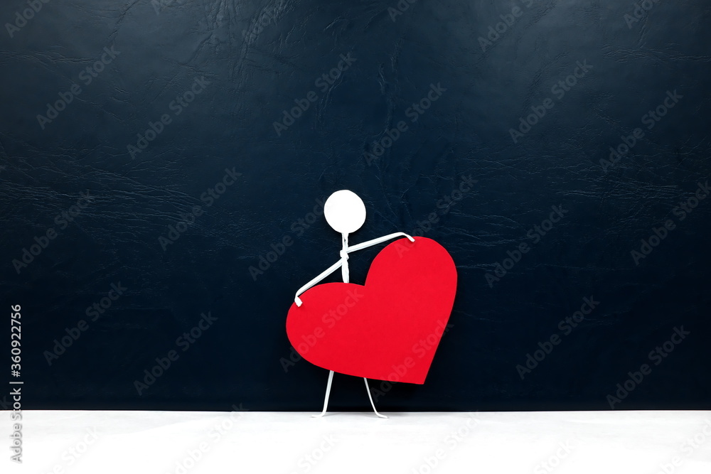 Human stick figure holding a big red heart in dark background. Give ...