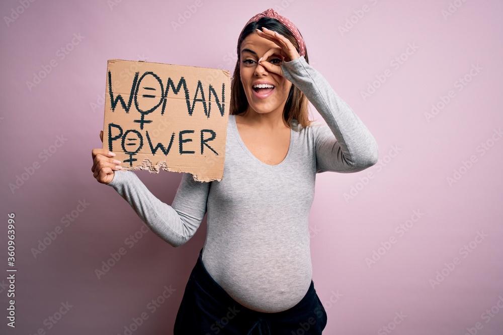 Young brunette woman pregnant expecting baby holding banner asking for ...