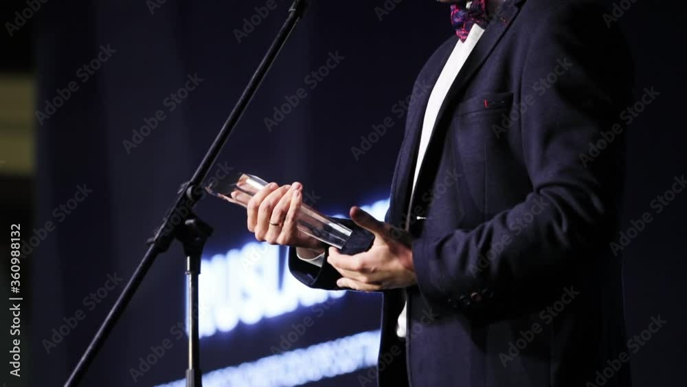 Stockvideo Middle shot of business man winner holding a champion trophy ...
