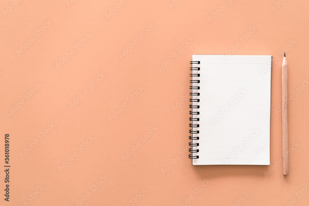 Notebook and pencil on pastel color texture background. Stock Photo ...