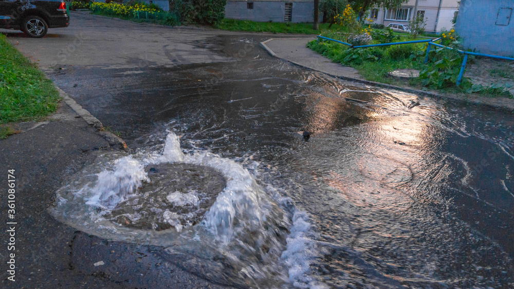 Photo & Art Print Water flows out of manhole from breakthrough sewerage ...
