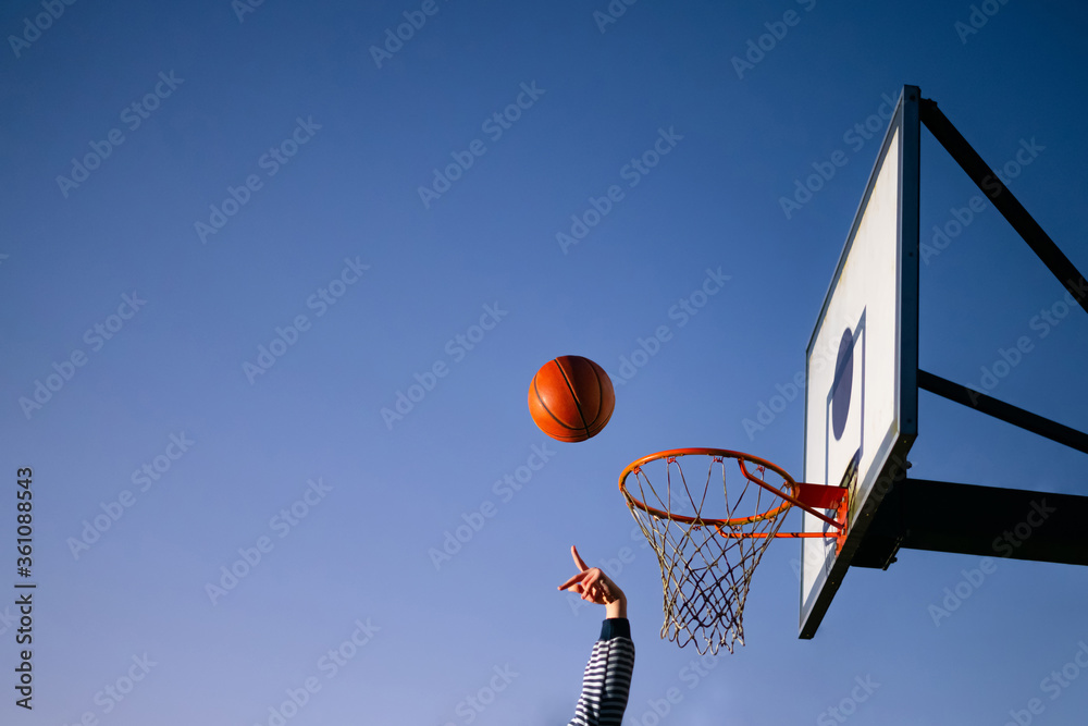 Street basketball ball player throwing ball into the hoop. Close up of ...