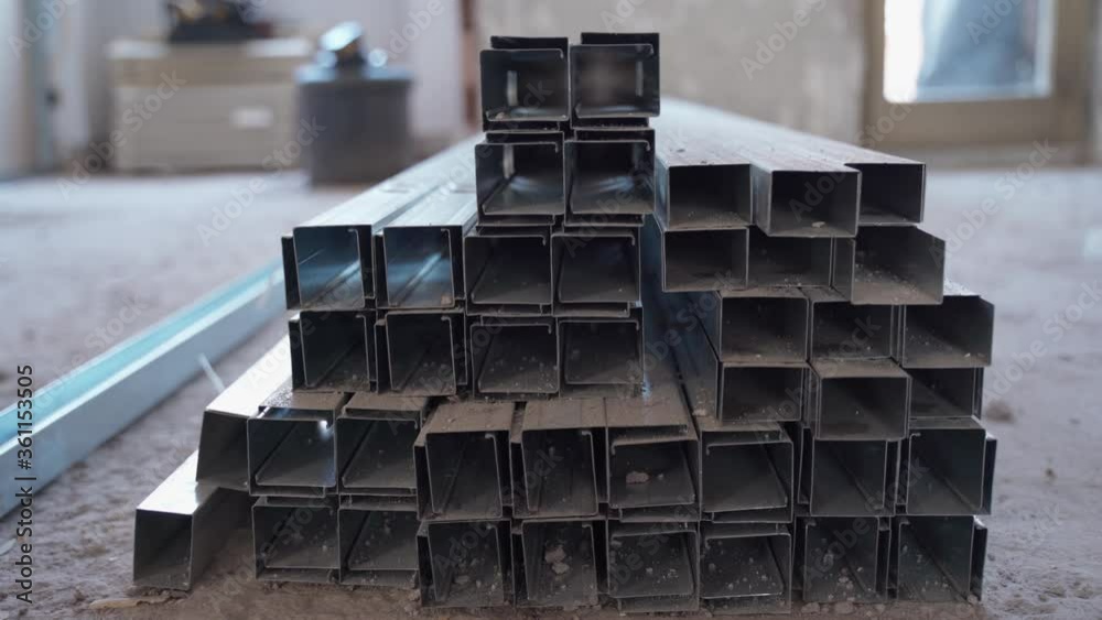 Wideo Stock: Stack of metal construction profiles on the ground in ...