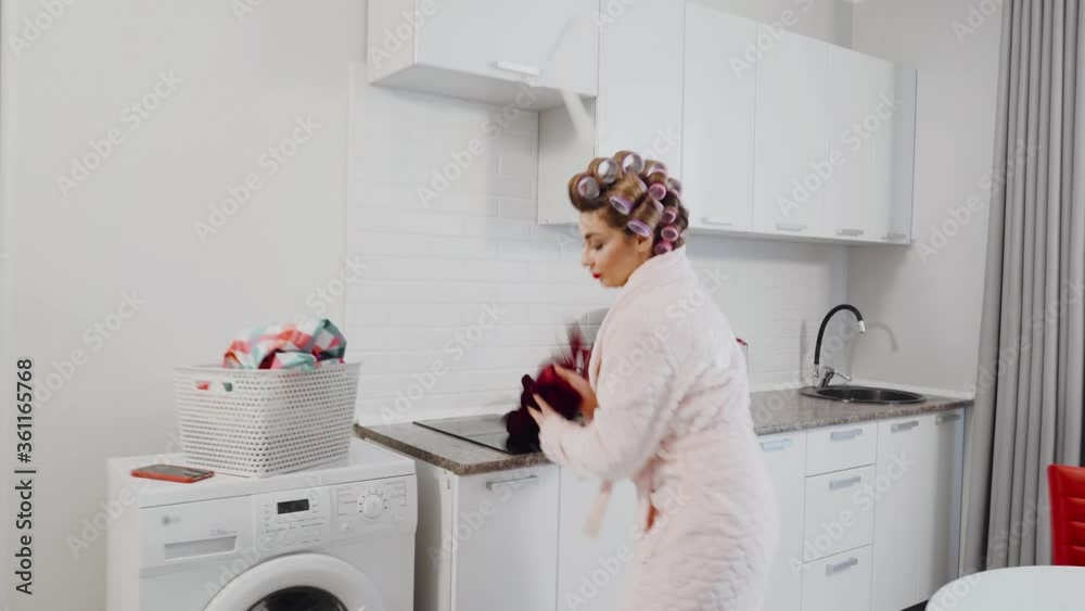 An agitated woman in a panic grabs the dress and wipes the water while ...