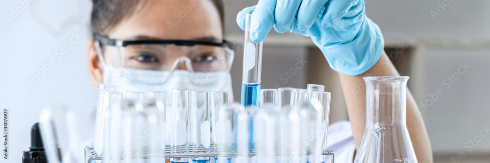 Scientist in lab working in laboratory using equipment for research ...