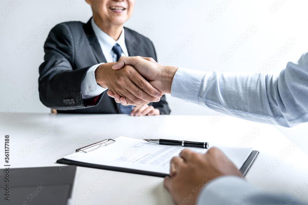 Male candidate shaking hands with Interviewer employer after a job ...