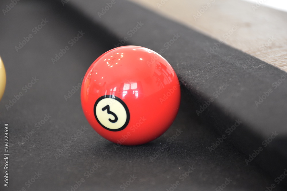 Black billiard table, Billiard balls in a pool table, focused on 3 ball ...