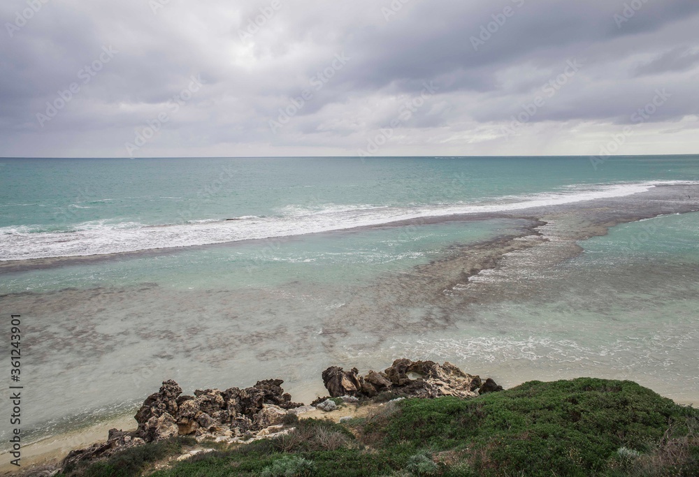 Green crystal clear sea water and horizon located at Trigg ocean coast ...