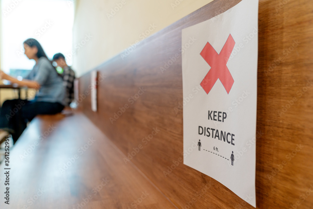 Keep distance paper sign on seat at restaurant. Arrangement blank space ...