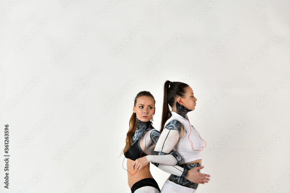 beautiful and warlike girls in robotic costumes as sisters are ready to ...