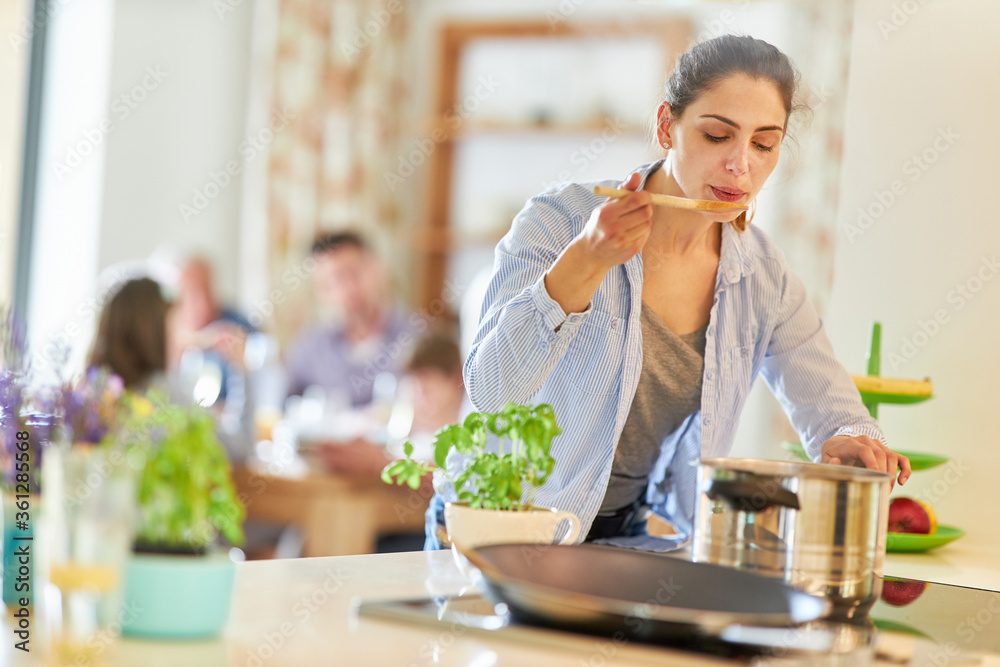 Young woman as a hobby cook while tasting Stock Photo | Adobe Stock