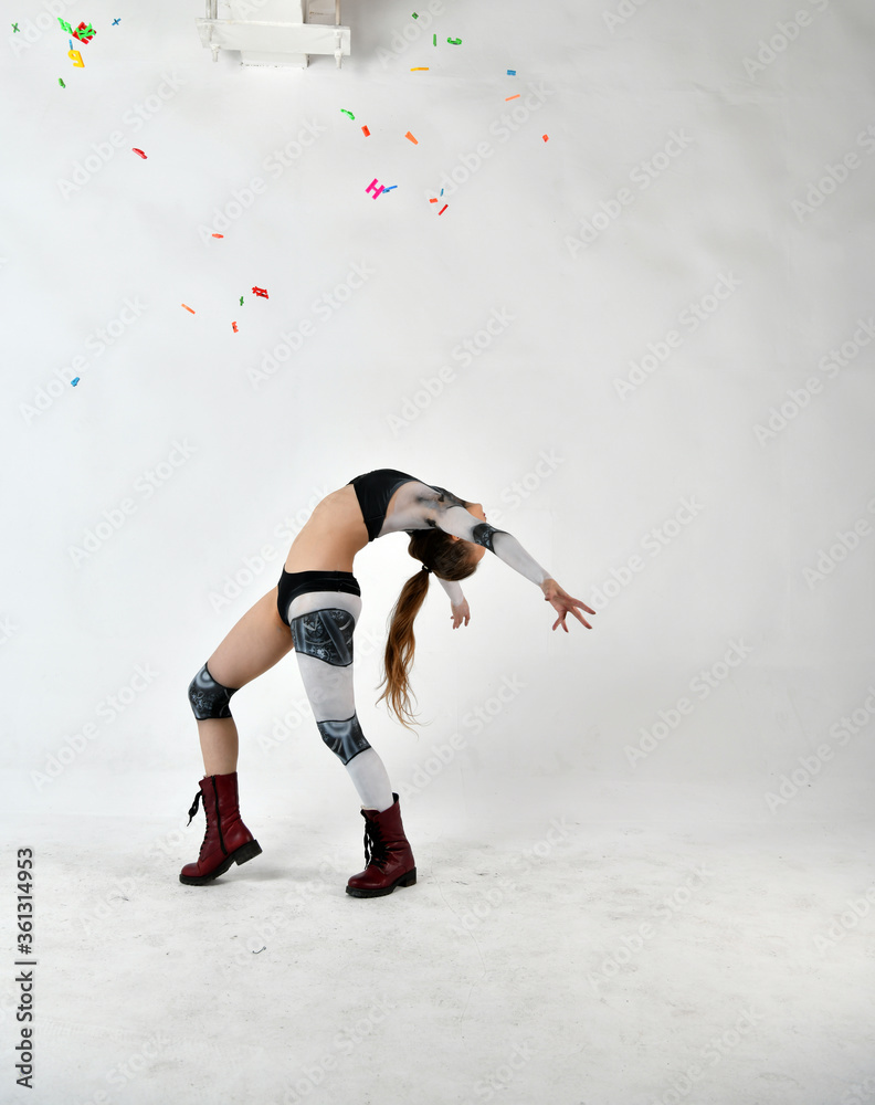 beautiful girl in a robot suit throws up multi-colored letters and does ...