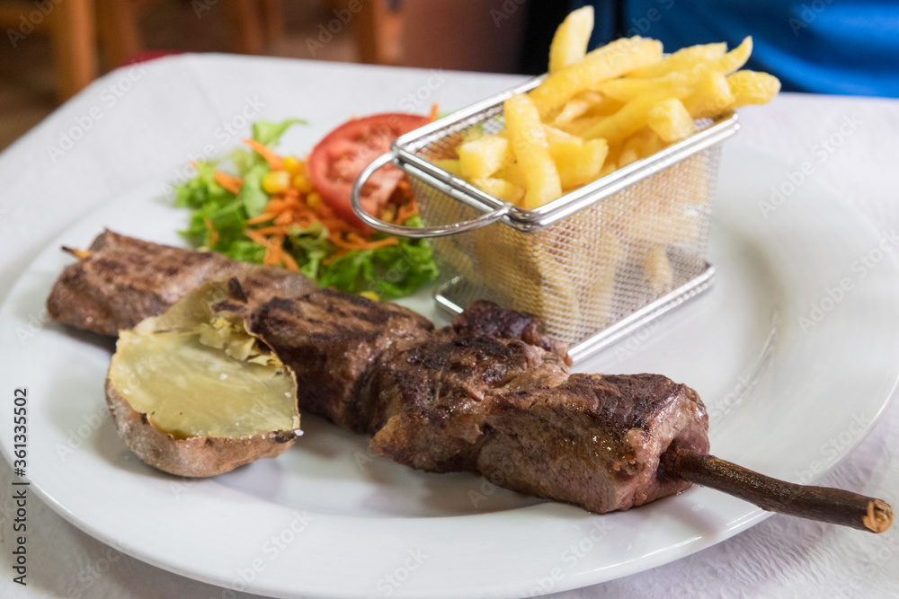 The traditional Madeira dish espetada or beef on a skewer, seasoned ...
