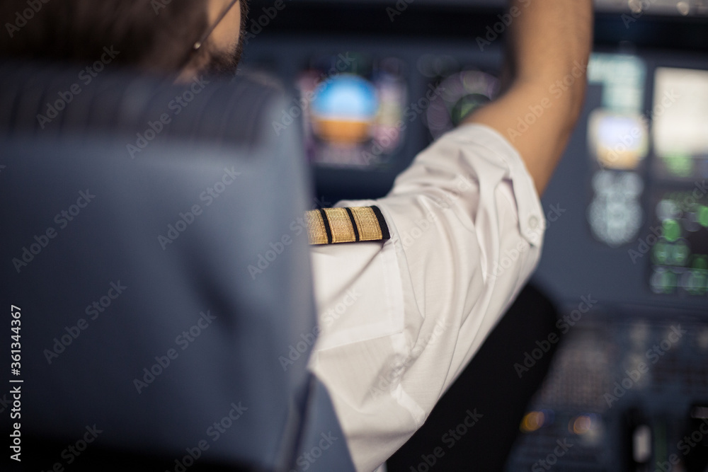 Young pilot in the aircraft in front of the dashboard. Pilot control ...